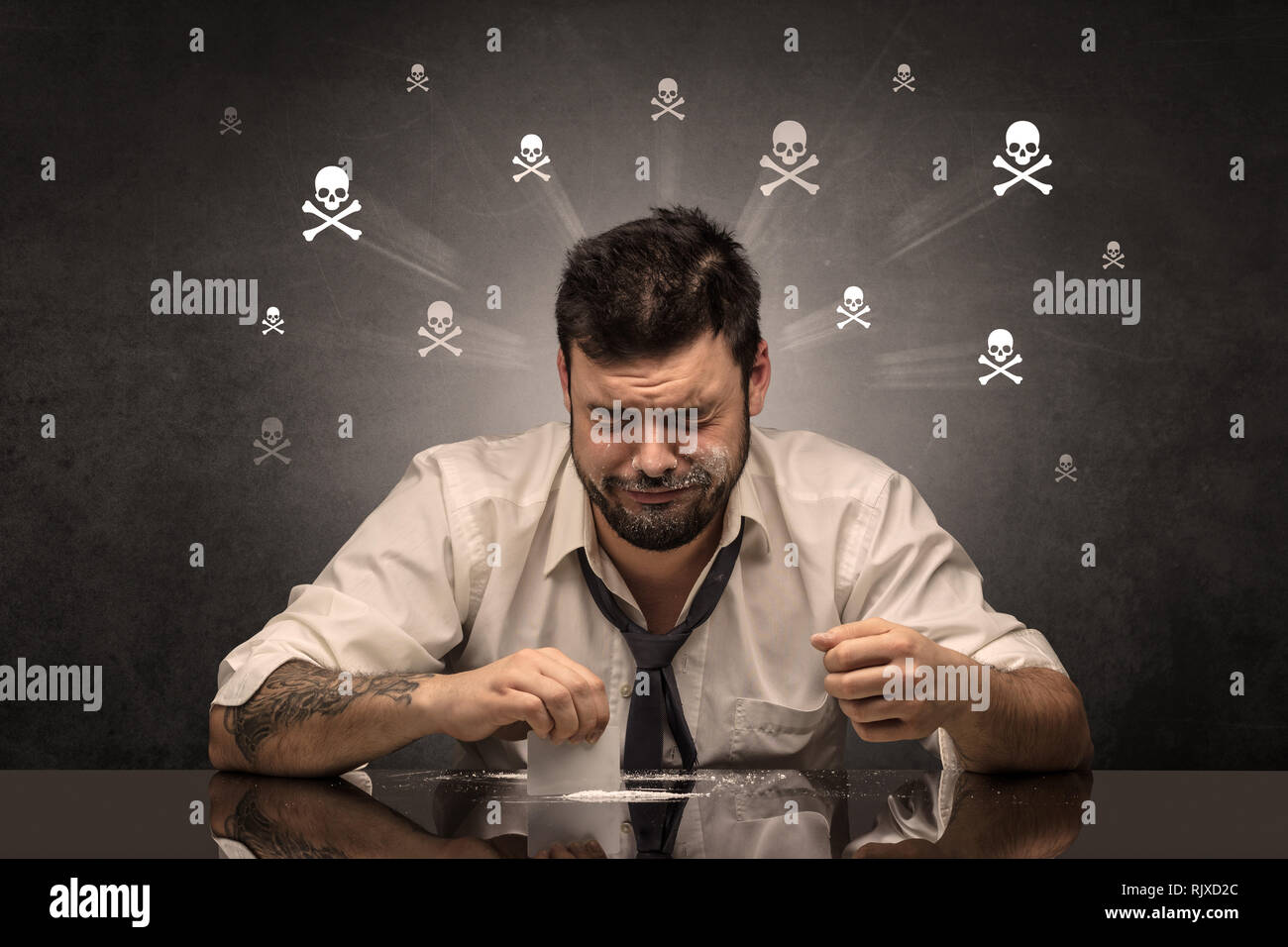 Loser drunk man sitting at table with skulls concept around Stock Photo ...