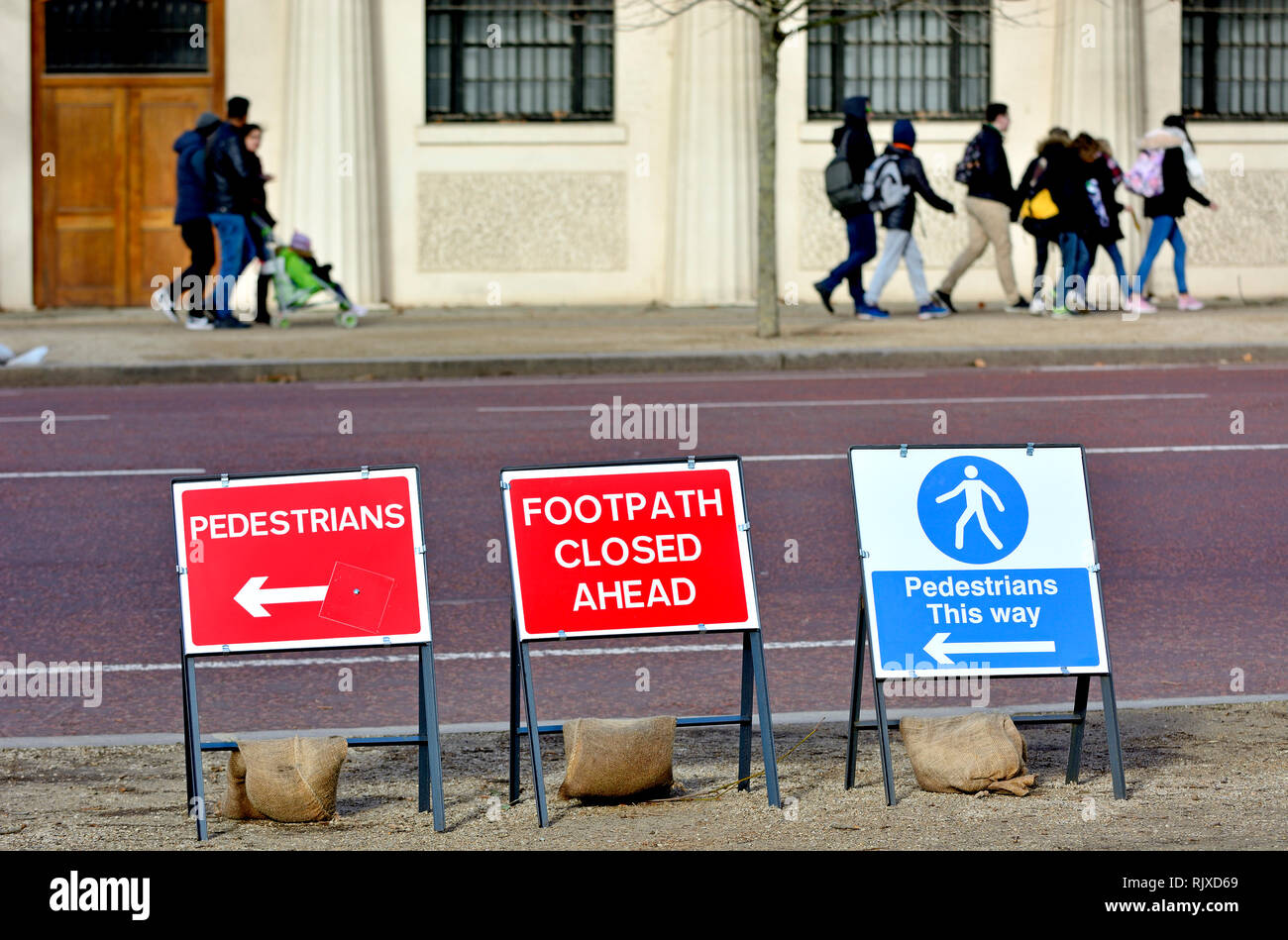 London, England, UK. Footpath Closed, Pedestrians This Way signs in the ...