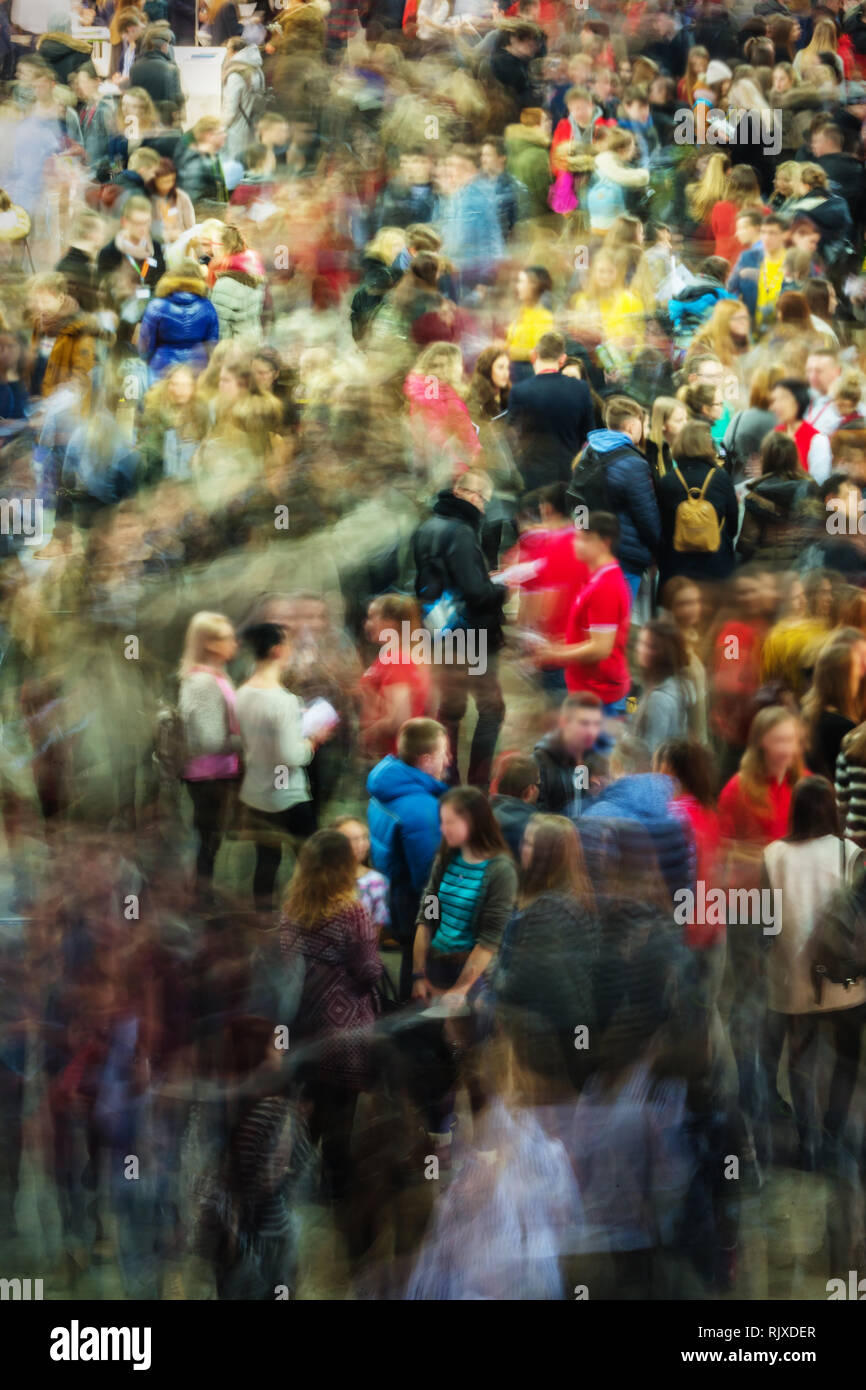 Long exposure photograph of people in an art fair, studies fair, motion ...