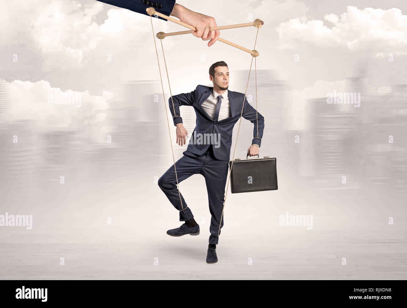 Puppet man with big city great power concept Stock Photo - Alamy