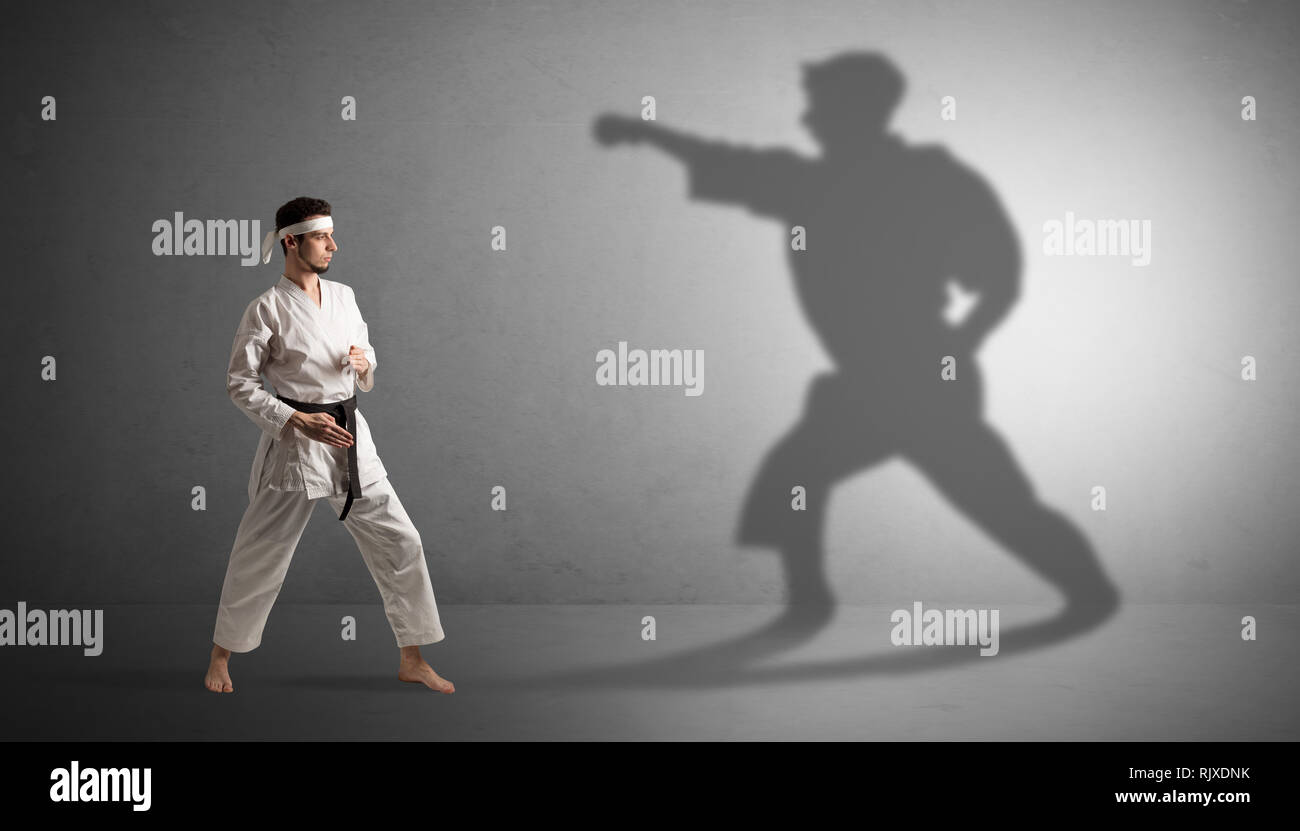 Young karate man confronting with his own shadow Stock Photo - Alamy
