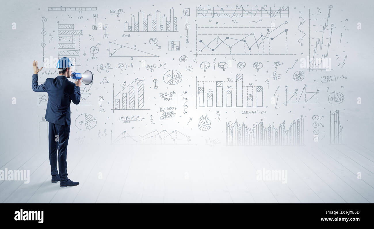 Engineer with construction helmet holding a plan and standing with ...