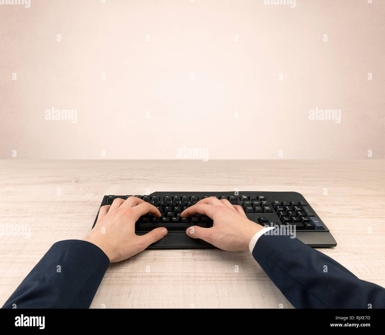 First person view of an elegant businessman hand typing on light ...