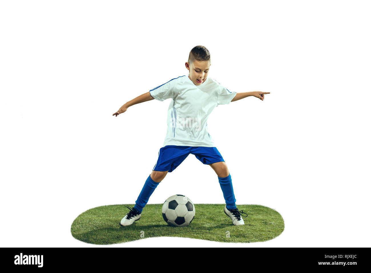 Young boy kicks the soccer ball. Isolated photo on white background ...