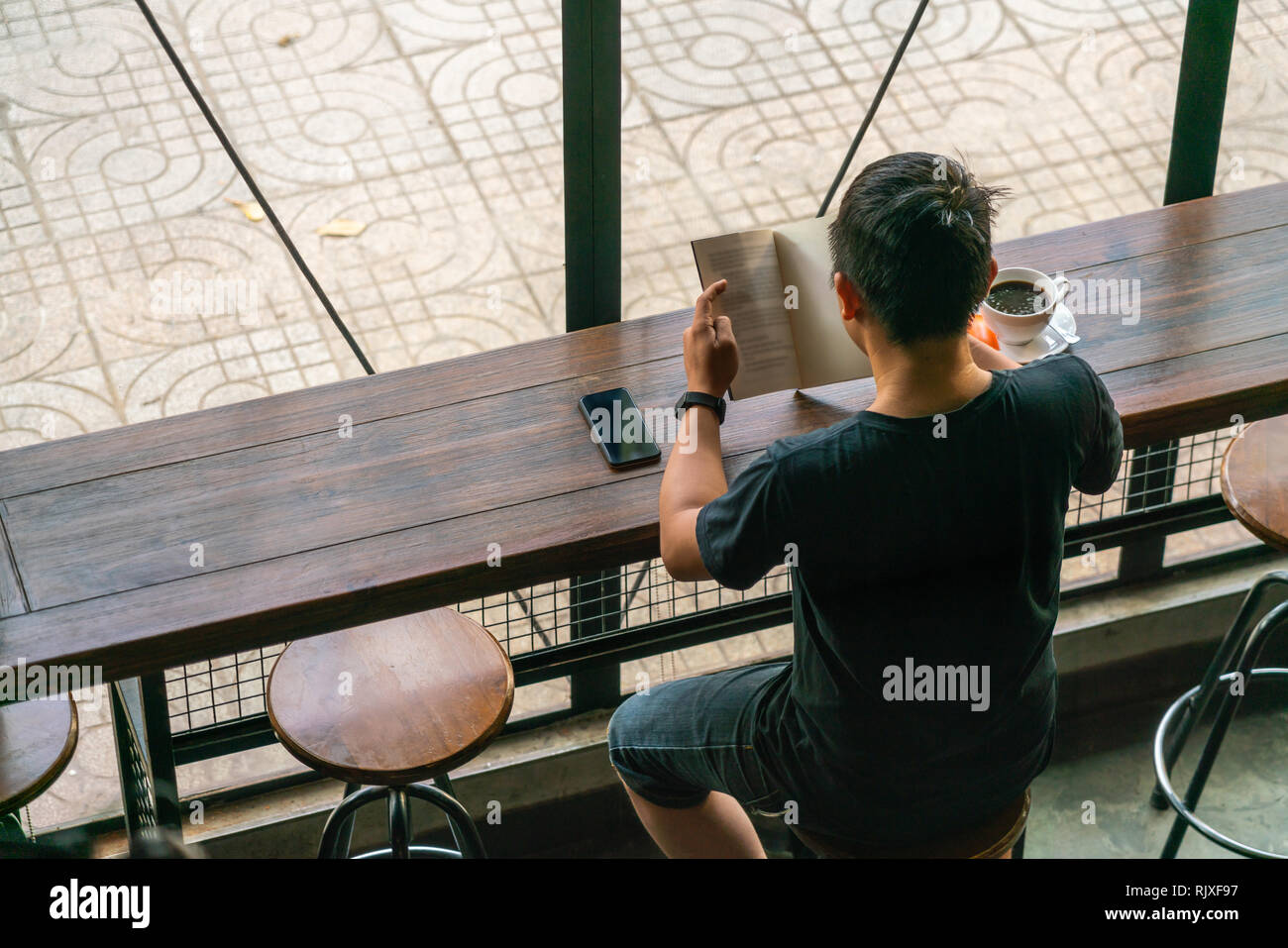 Asian man reading book drinking hi-res stock photography and images - Alamy