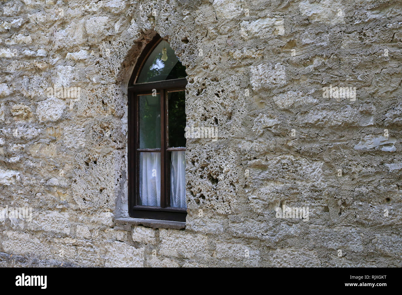 Window in a wall of natural stone Stock Photo - Alamy