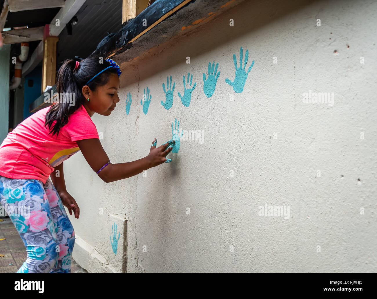young latin girl making hand prints in Guatemala Stock Photo - Alamy
