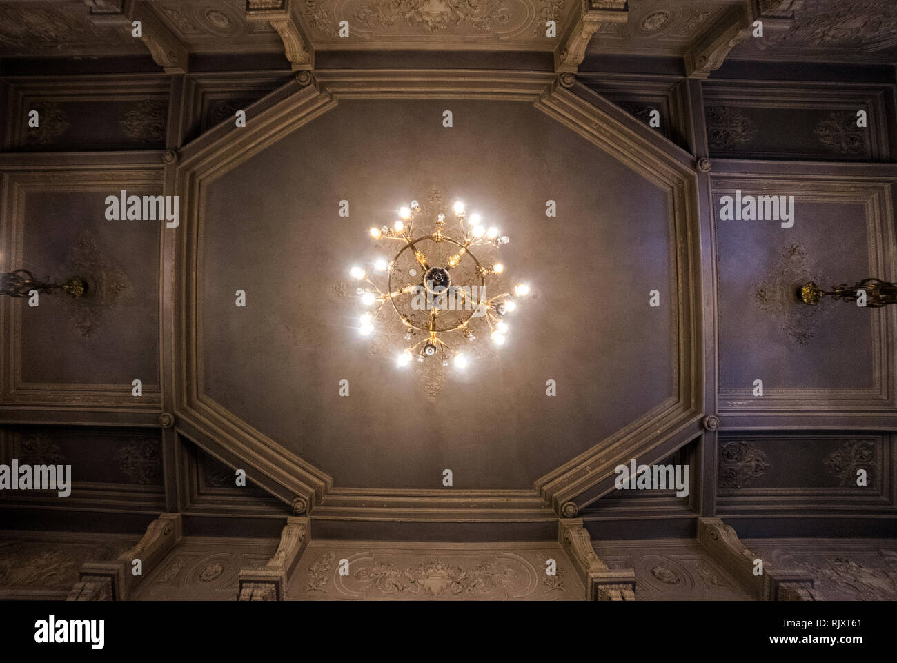 Looking up at old church ceiling. Chandelier light and classic indoor ...