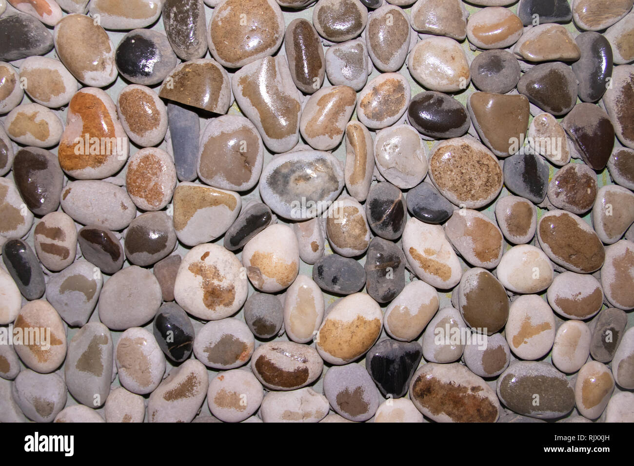 The texture of the wall of round stones. Stone wall Backgrounds and ...