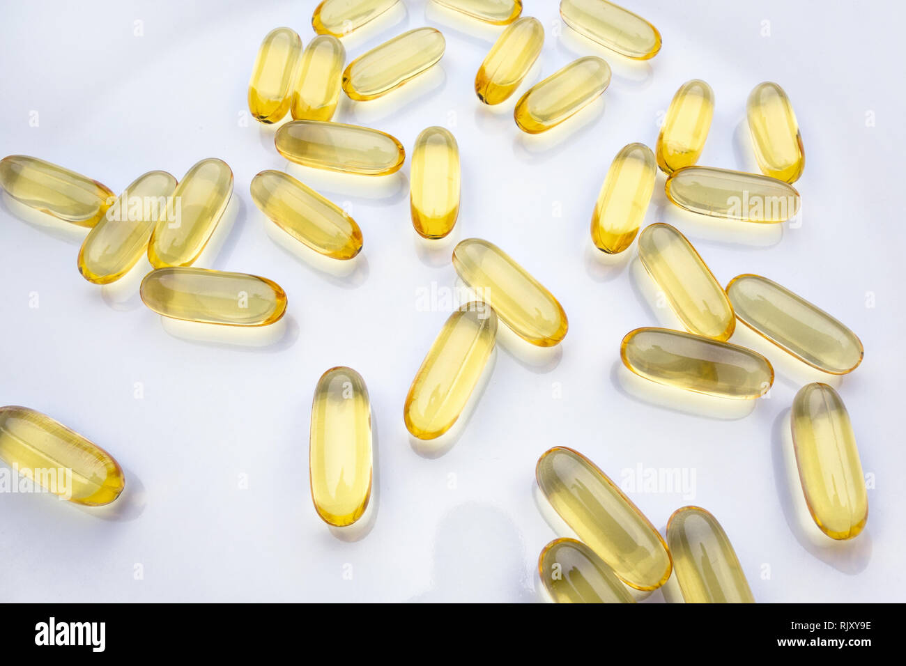 Transparent capsules scattered on a light background Stock Photo - Alamy