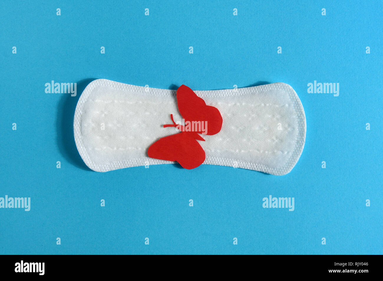 compress for menstruation on blue background Stock Photo - Alamy