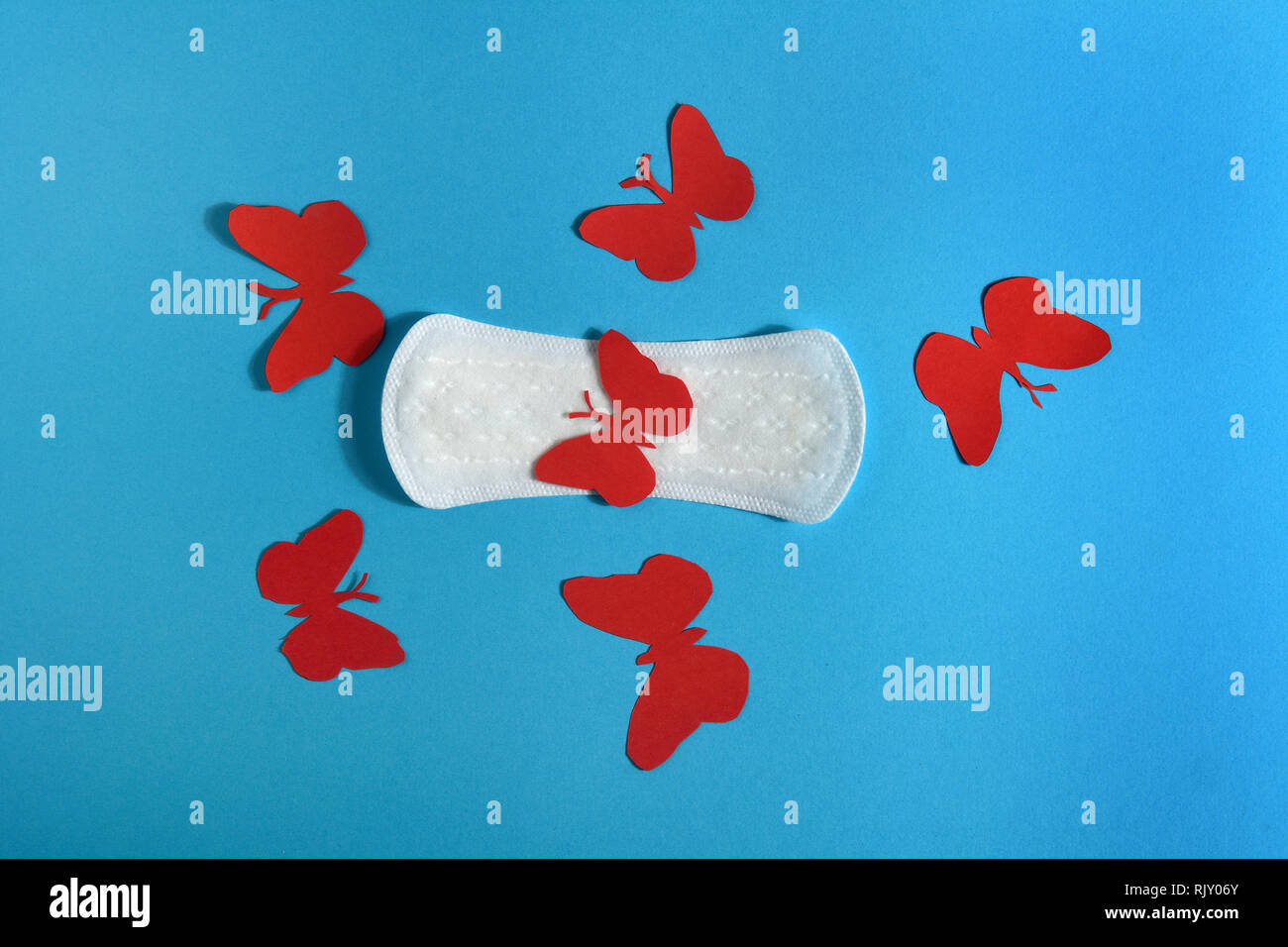 compress for menstruation on blue background Stock Photo - Alamy