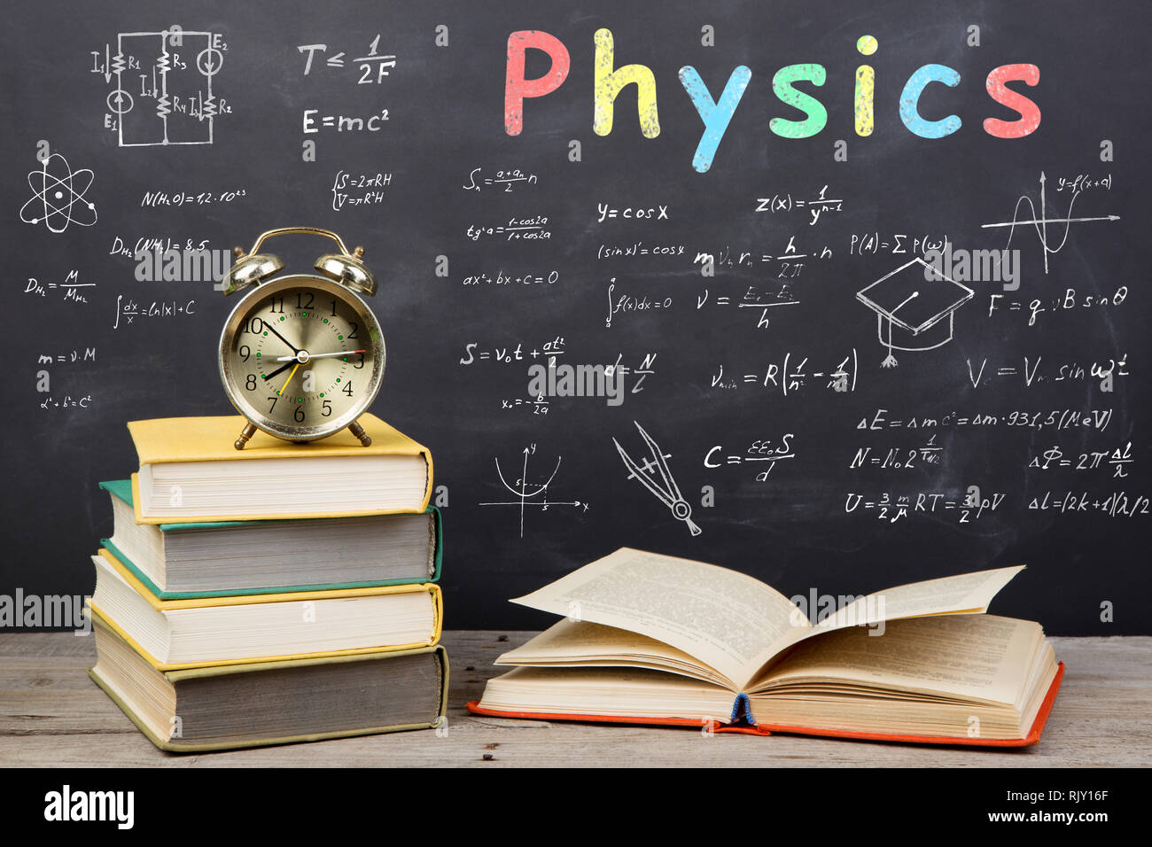 Education concept - books on the desk in the auditorium, formulas and ...