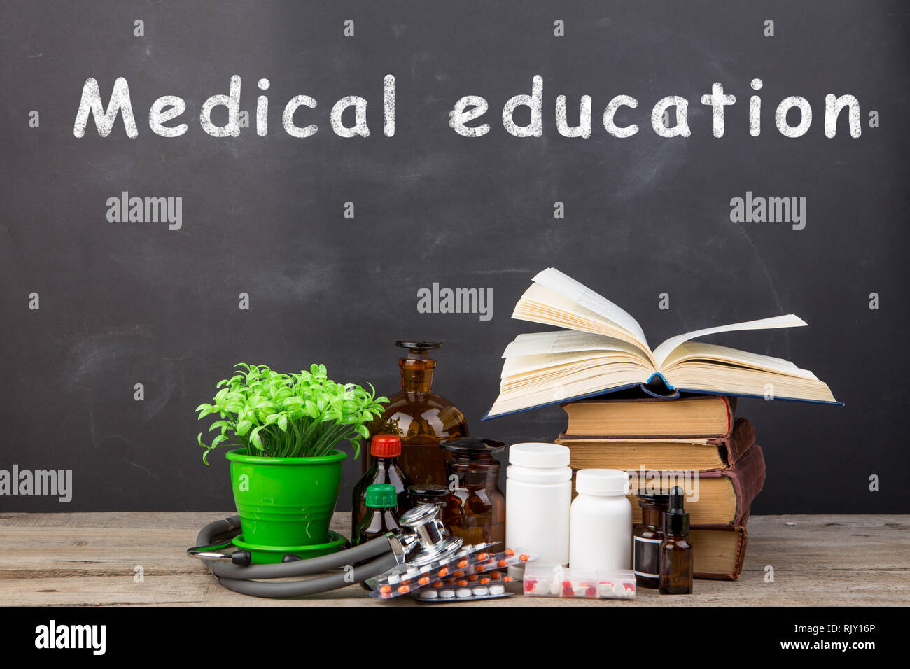 Medical education concept - books, pharmacy bottles, stethoscope in the ...