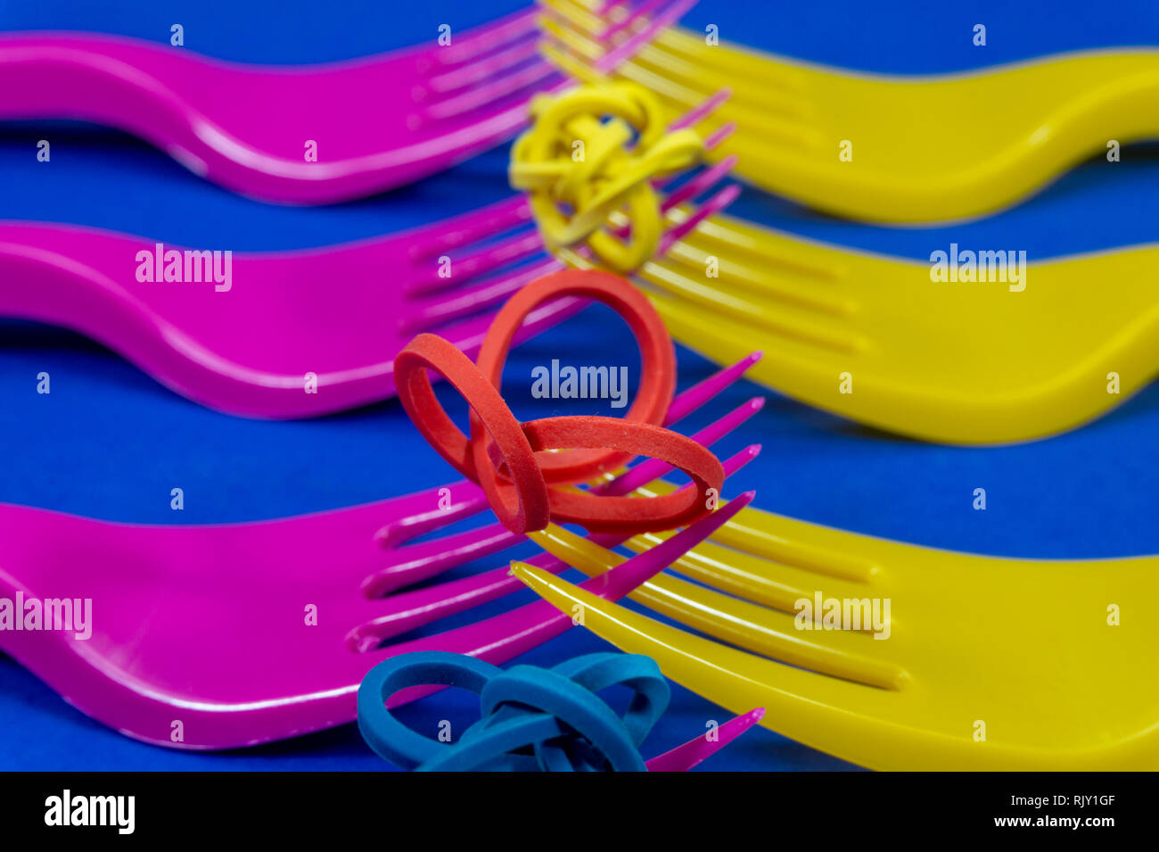 Colorful purple and yellow plastic forks with interlocking prongs and ...