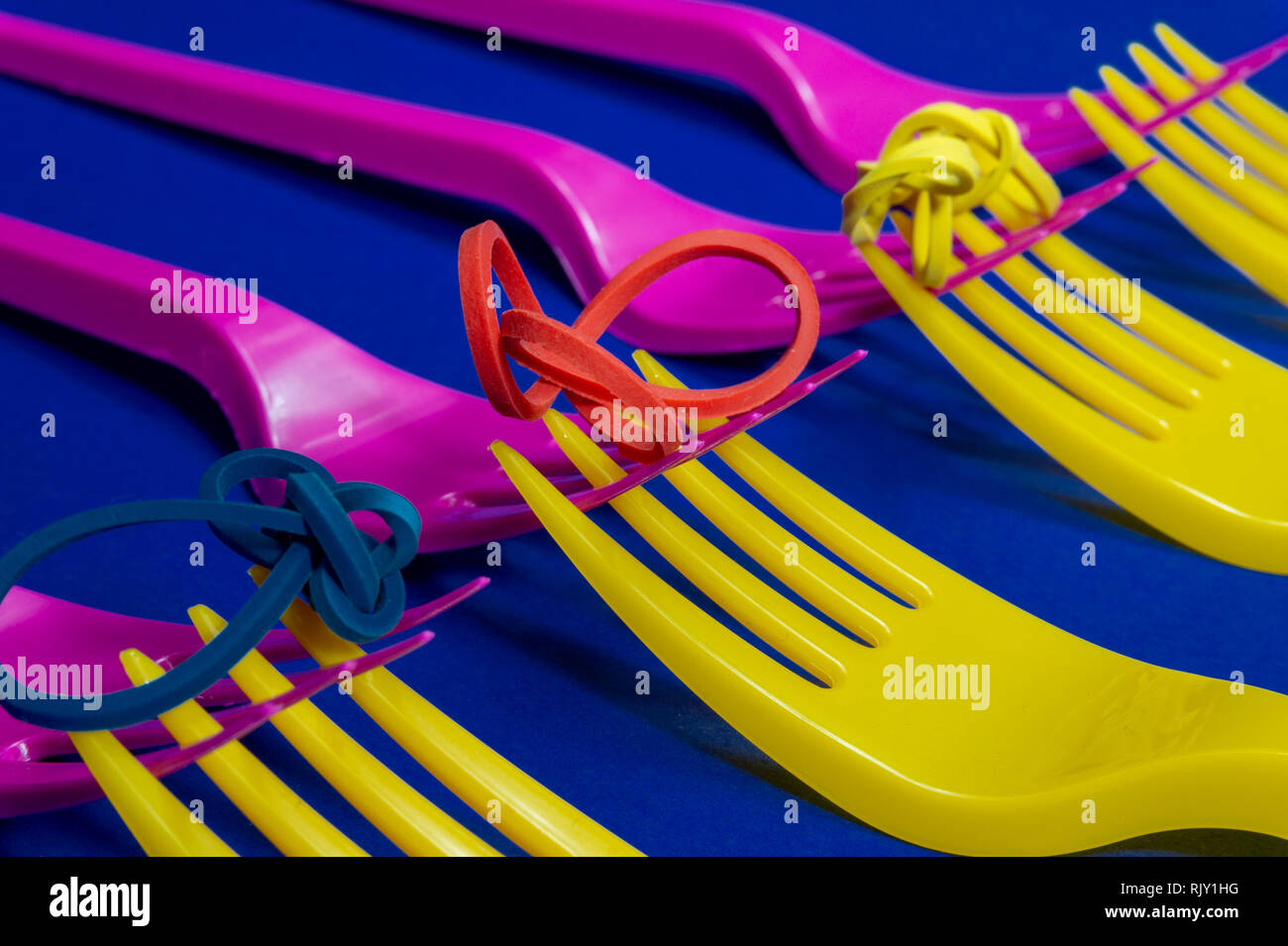 Colorful purple and yellow plastic forks with interlocking prongs and ...