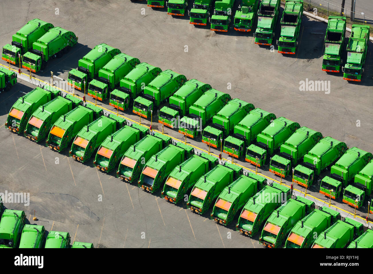 Aerial view of green garbage trucks in a row in parking lot Stock Photo ...