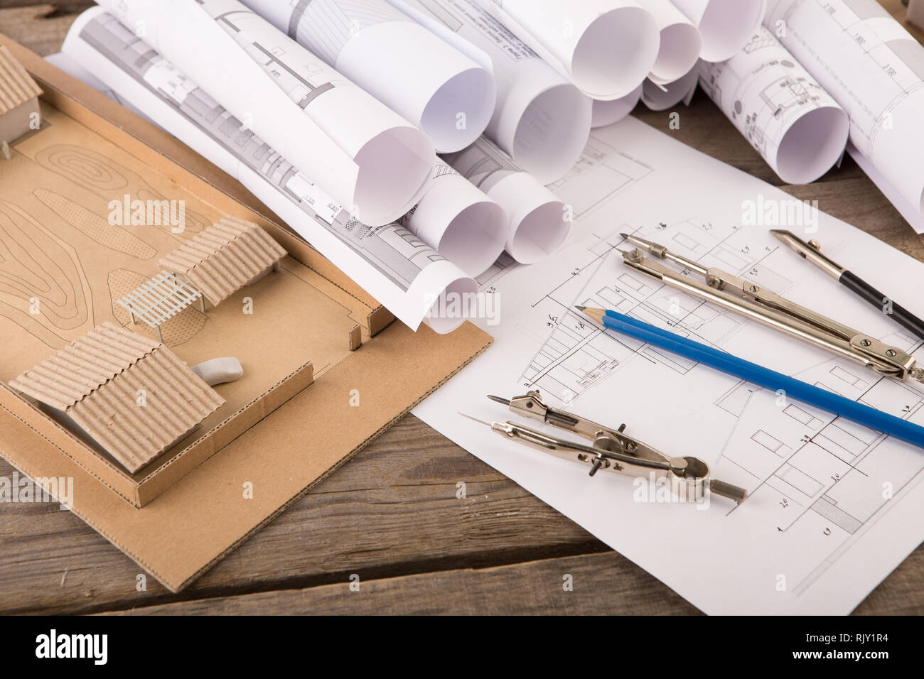 Workplace of architect - construction drawings, scale model of a house ...