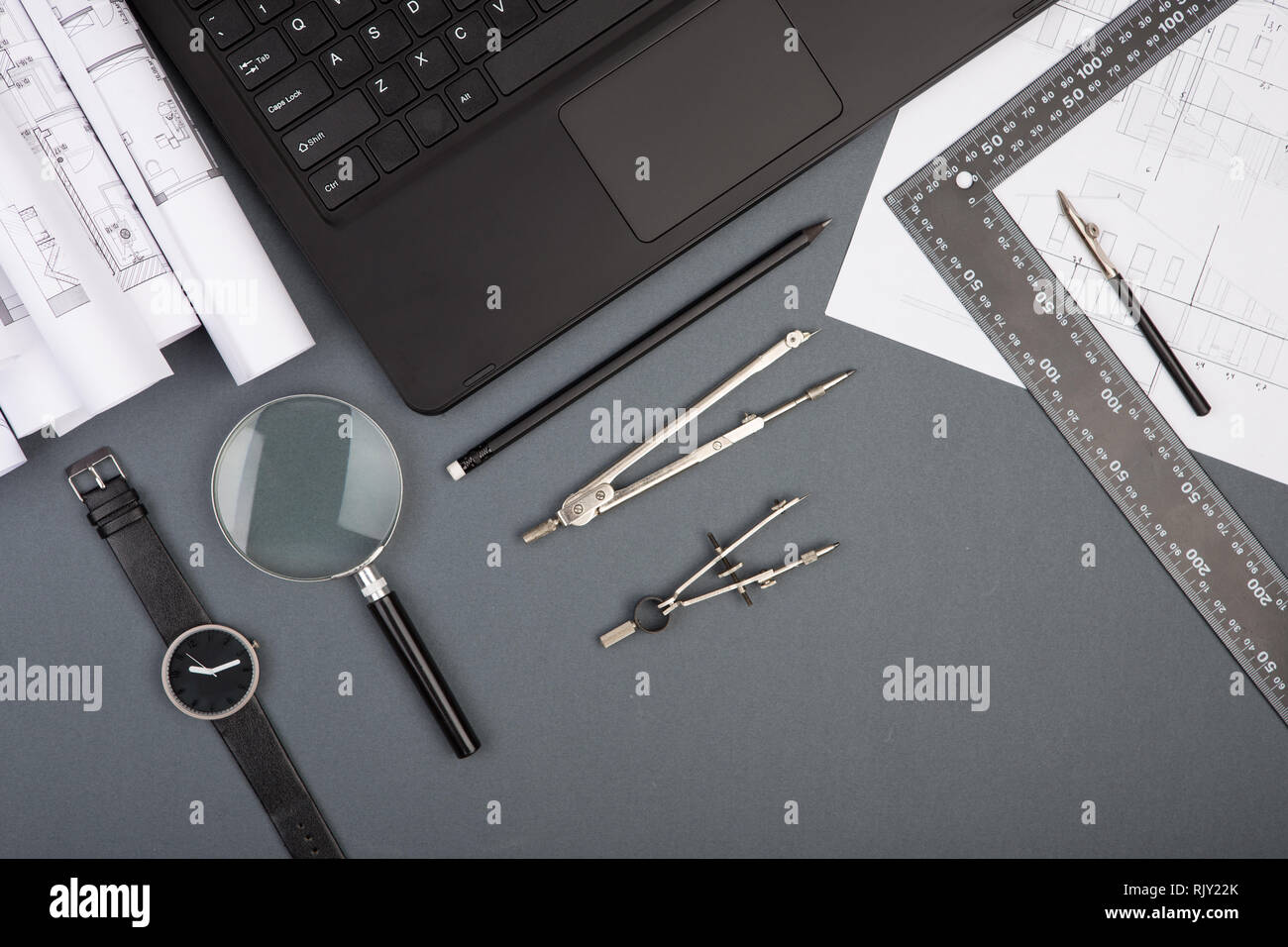 Workplace of architect - construction drawings,laptop, scale model of a ...