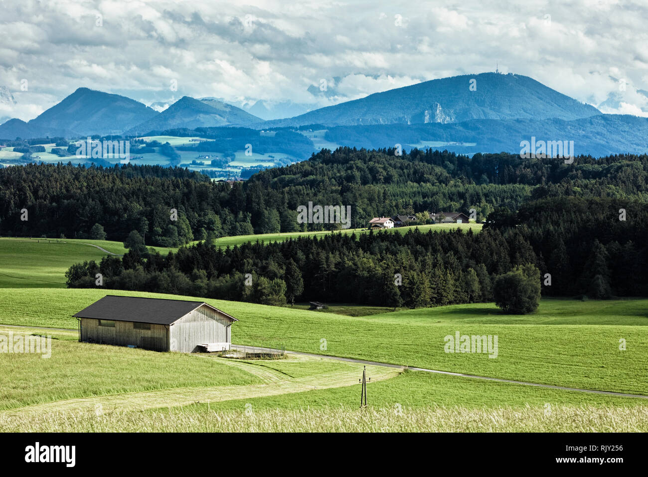 Barn in Field with Mountain Background Stock Photo - Alamy