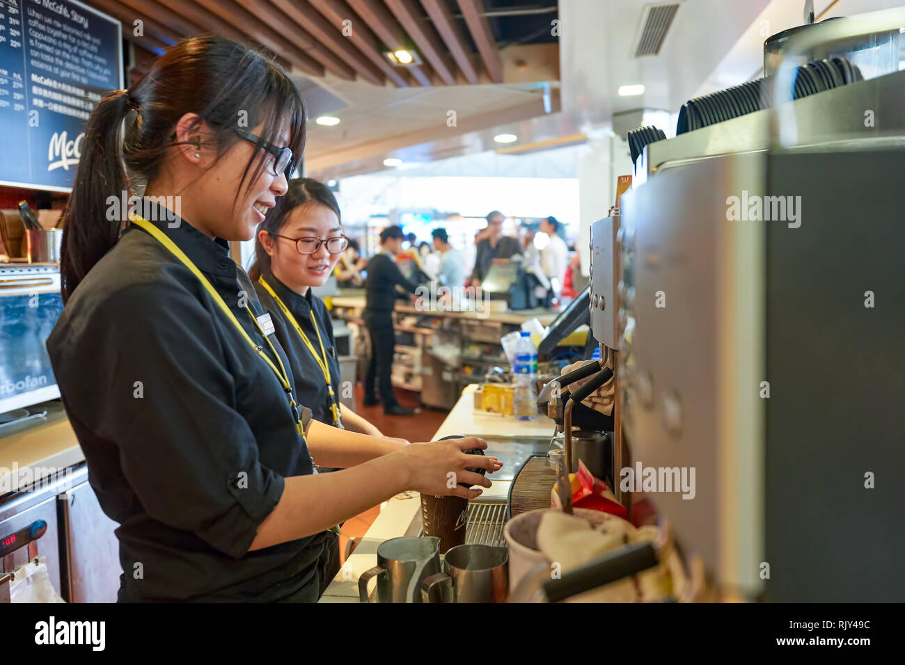 HONG KONG - MARCH 08, 2016: worker at McCafe in the Airport. McCafe is ...