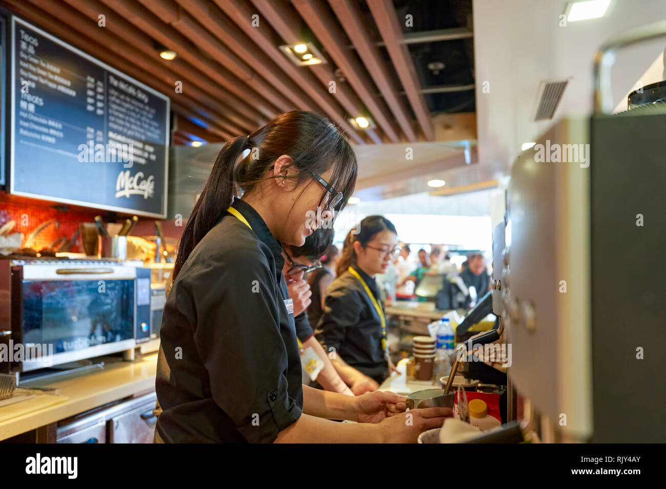 HONG KONG - MARCH 08, 2016: worker at McCafe in the Airport. McCafe is ...