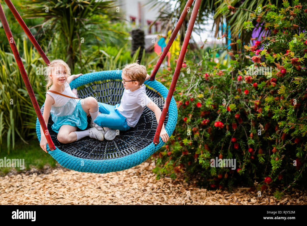 children playing in the park with swing Stock Photo - Alamy