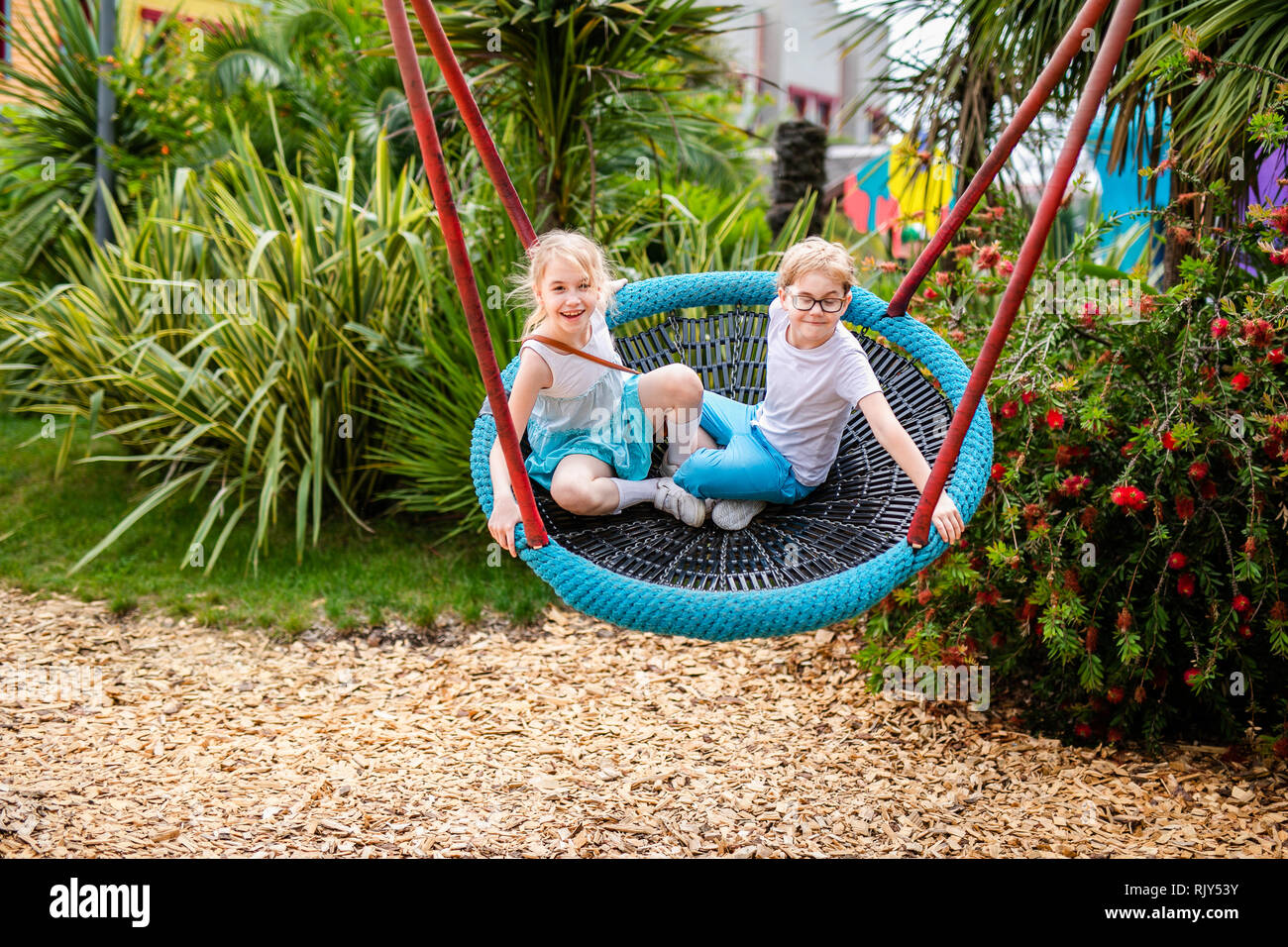 children playing in the park with swing Stock Photo - Alamy