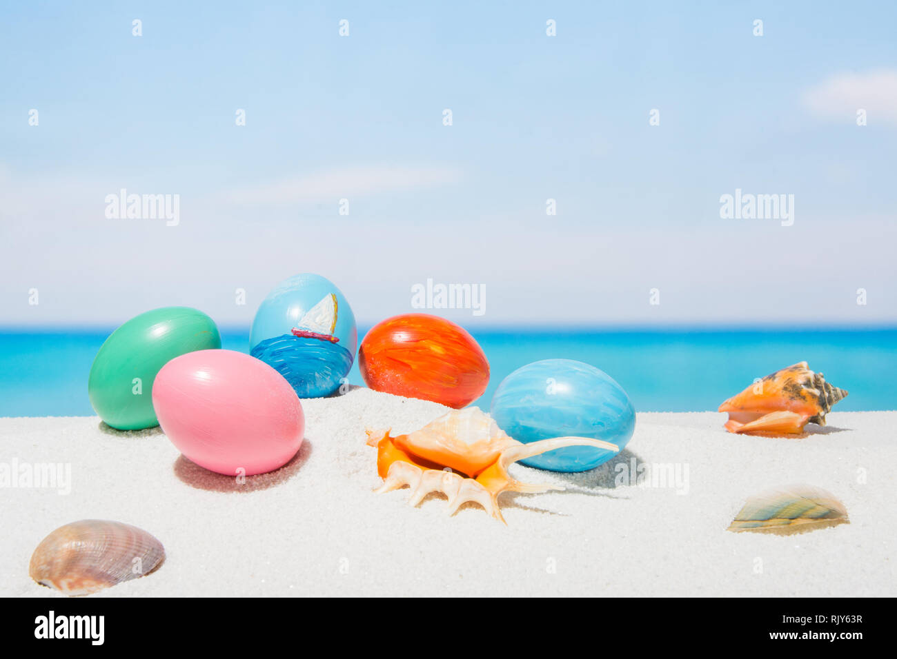 Easter on tropical beach background. Eggs on the white sand. Vacation ...