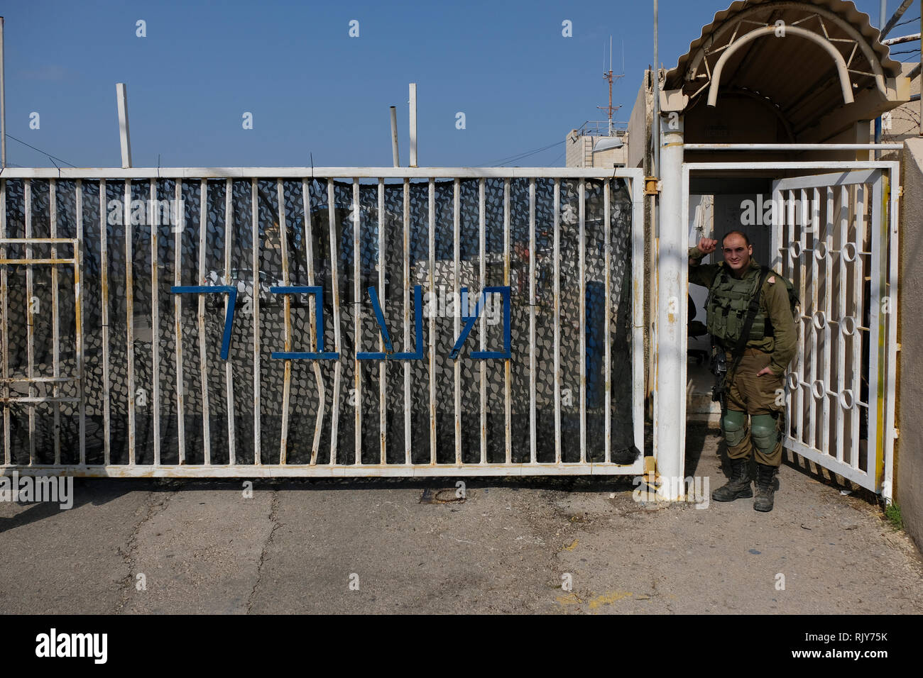 An Israeli soldier stands guard the gate of the Rosh Hanikra Crossing ...