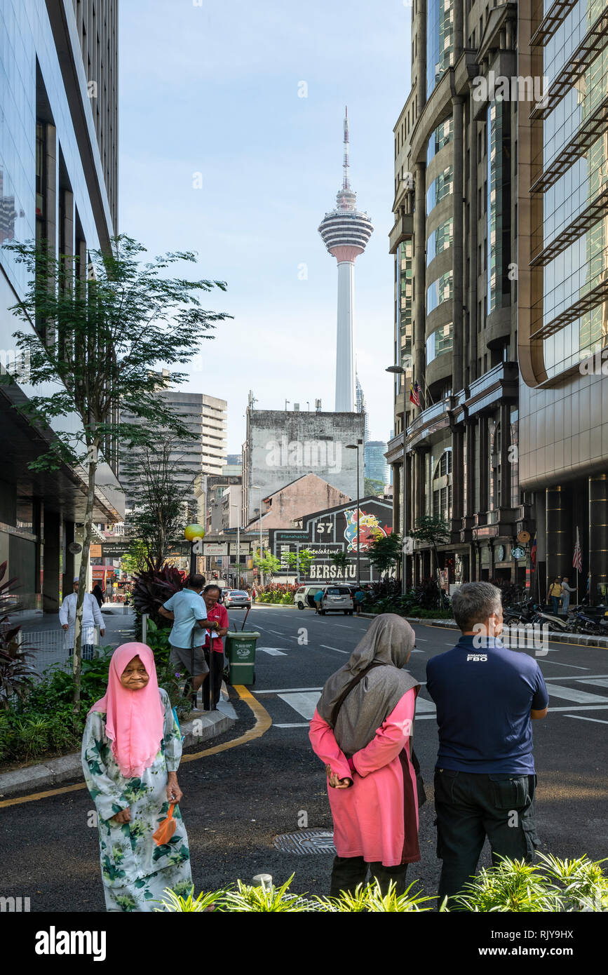 People on the streets with the Menara tower in the background in Kuala ...