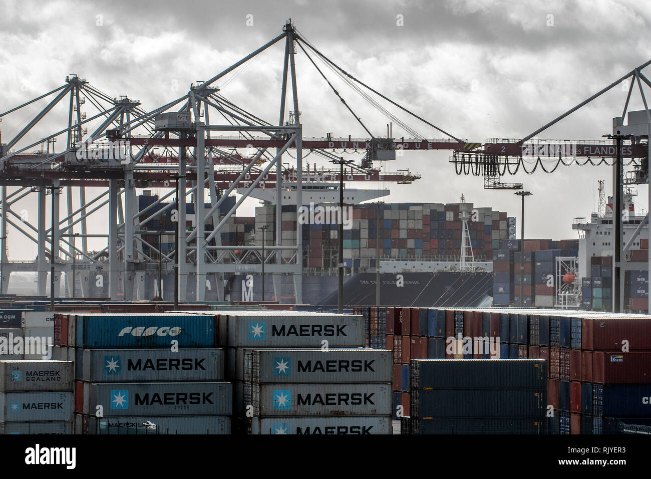 The port of Dunkerque in Northern France. Cranes load container ships ...