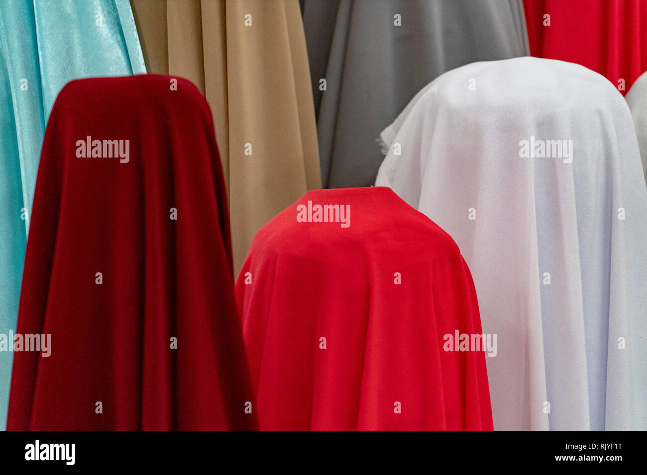 fabric for sale looks like burqa different colors Stock Photo - Alamy