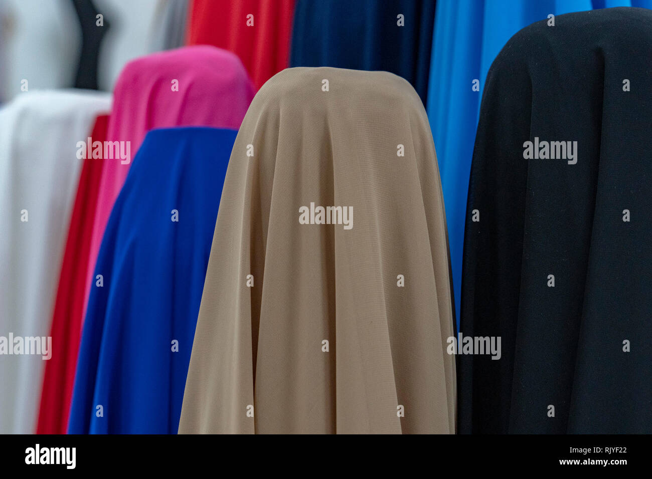 fabric for sale looks like burqa different colors Stock Photo - Alamy