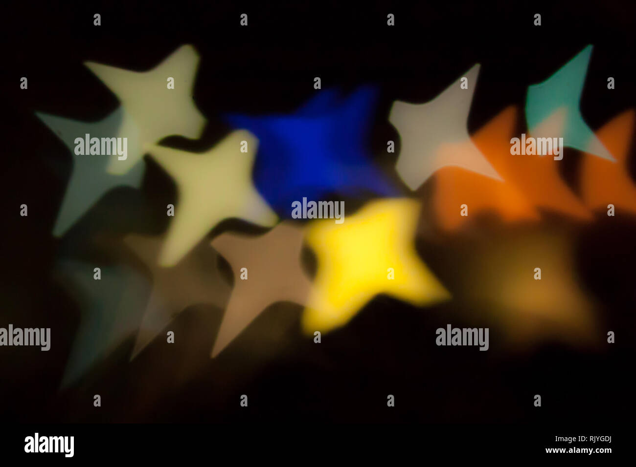 Blurred photo of defocused bokeh colorful lights in the shape of star ...