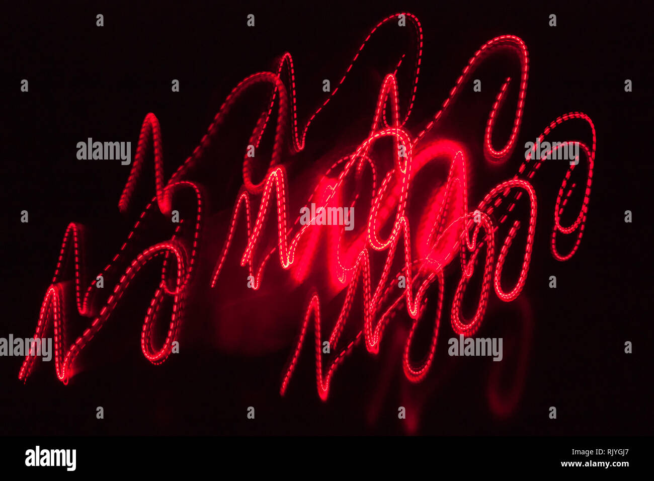 Abstract blurred red light effect on a black background. Long exposure ...
