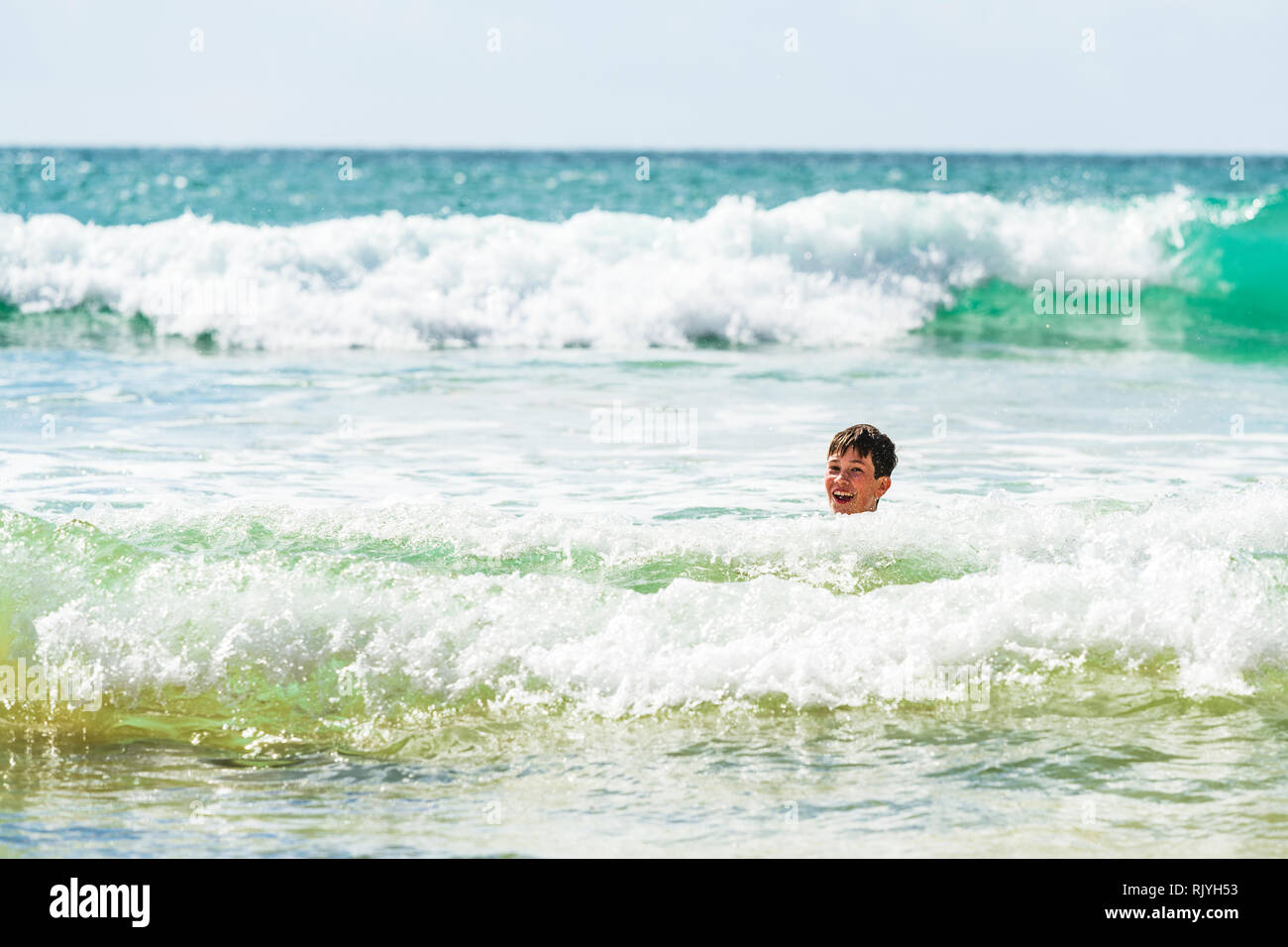 Children playing in the waves hi-res stock photography and images - Alamy