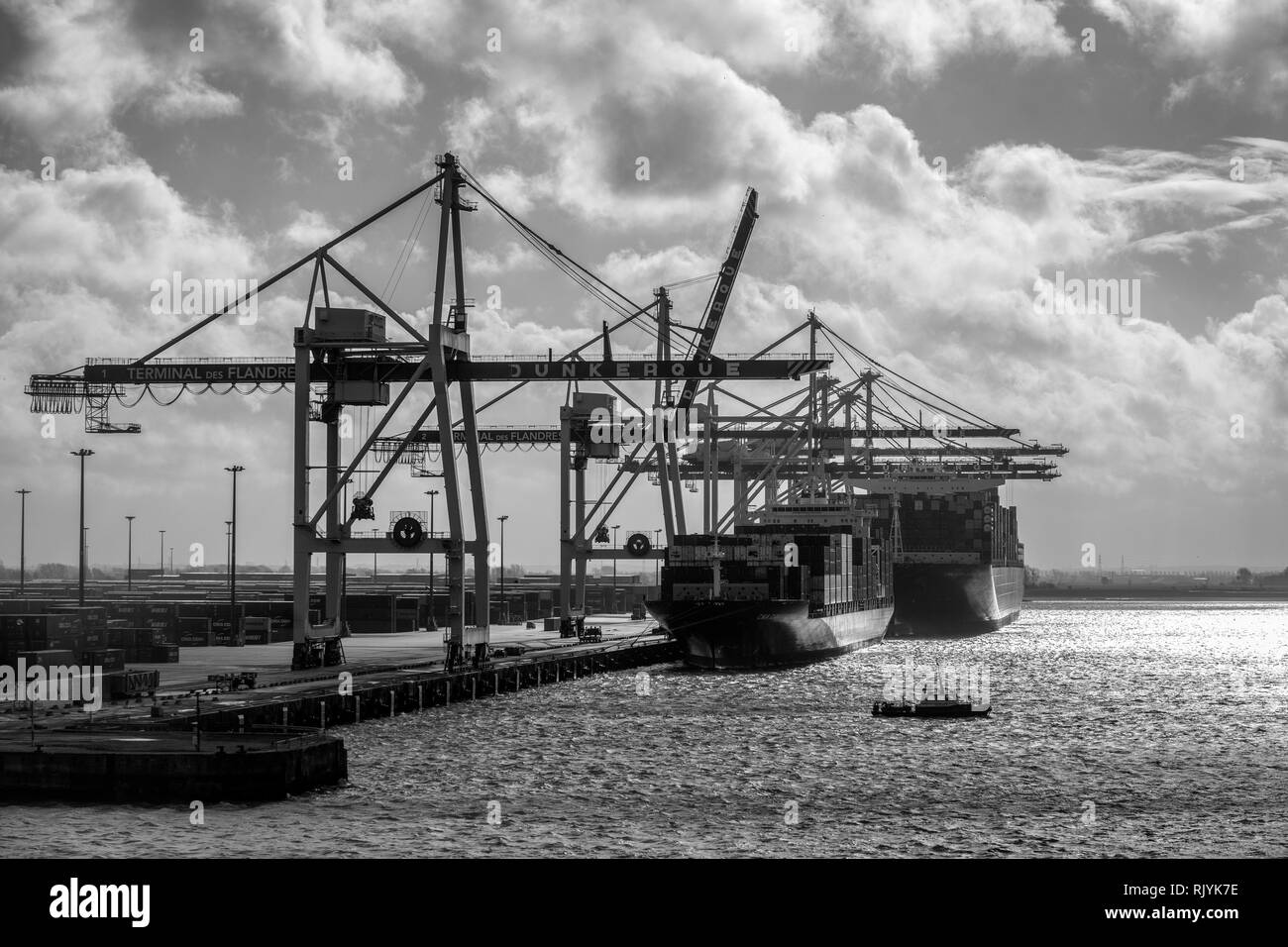 The port of Dunkerque in Northern France. Cranes load container ships ...