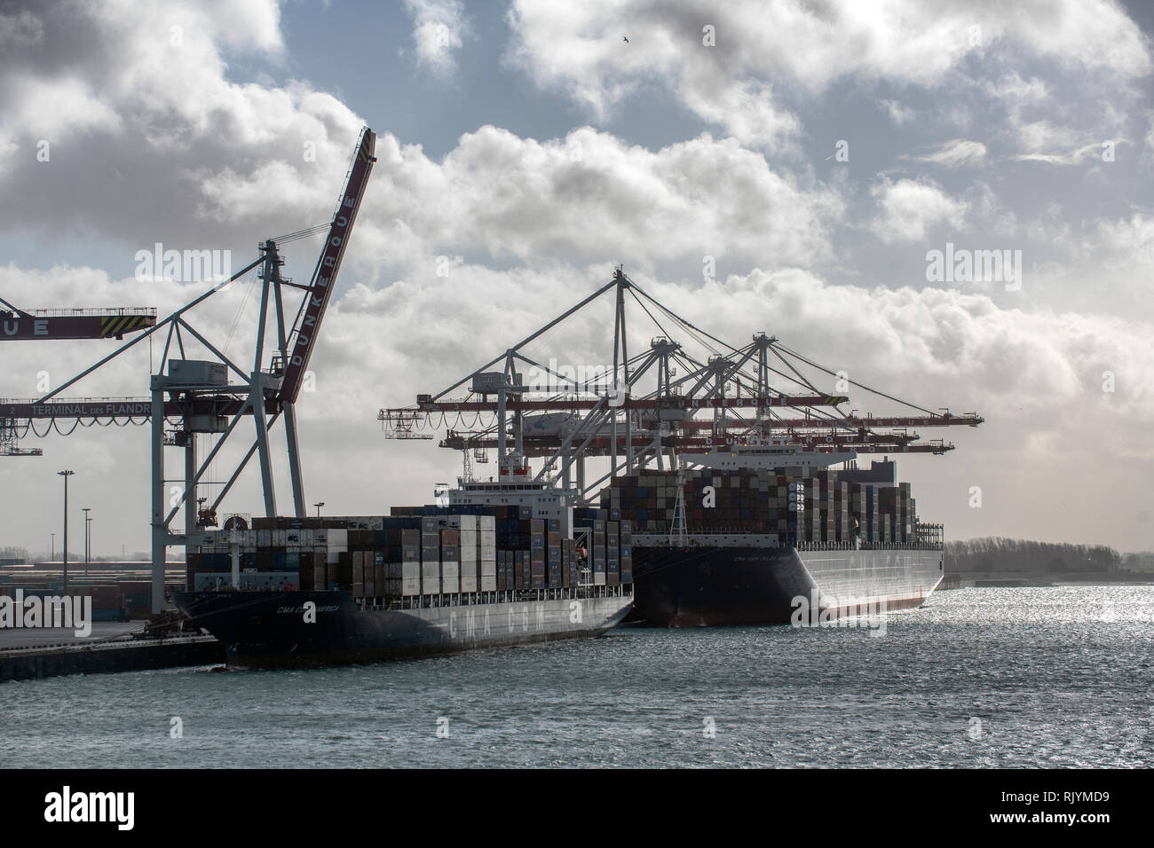 The port of Dunkerque in Northern France. Cranes load container ships ...