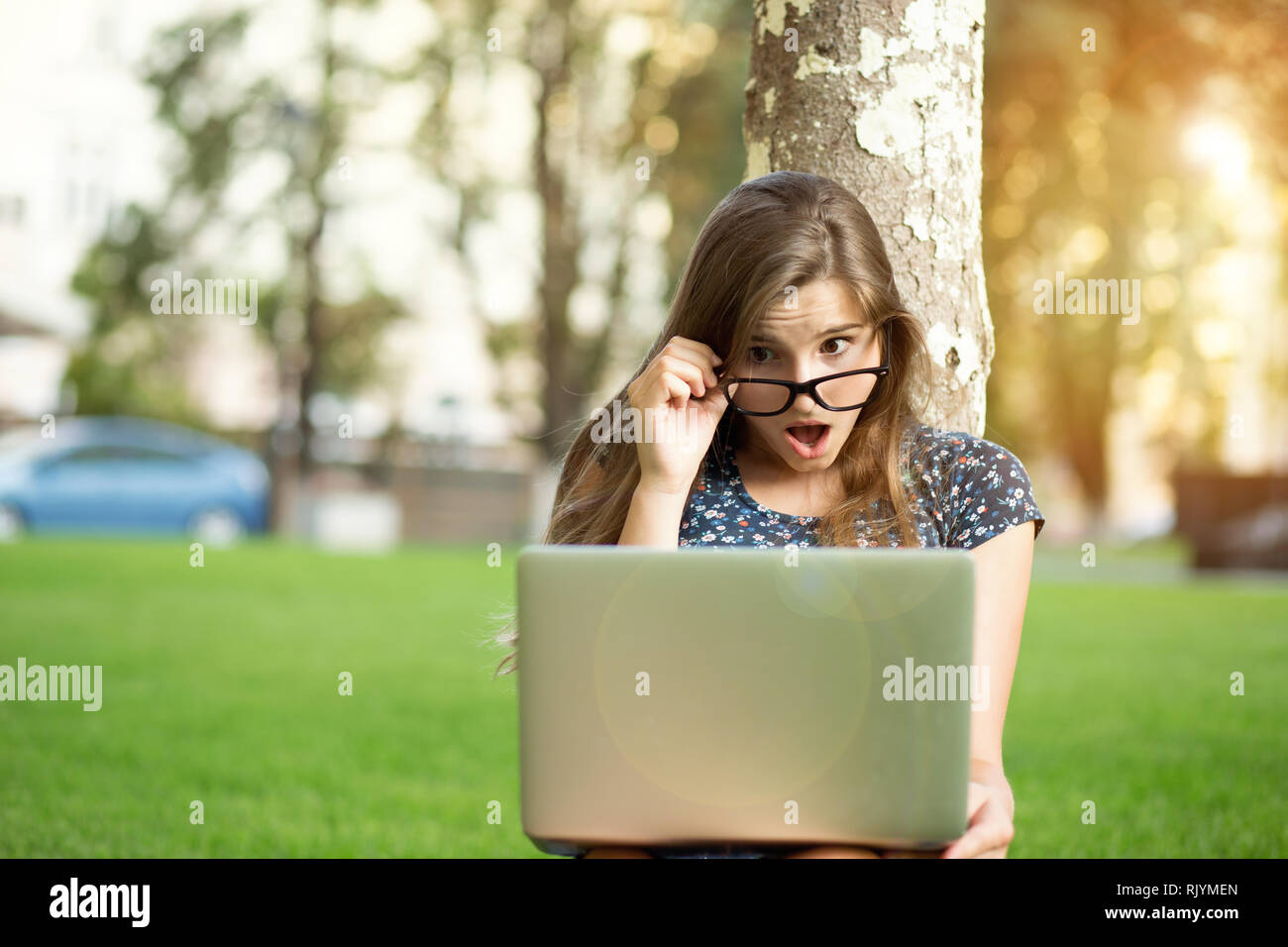 Shocked teenager looking at computer stunned Stock Photo - Alamy