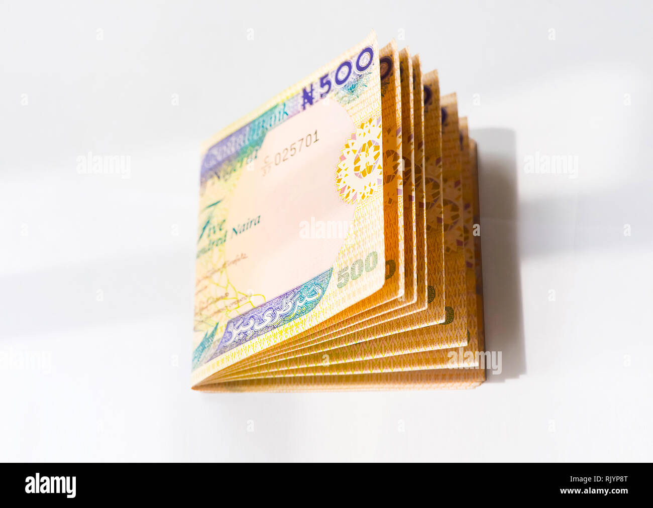 Nigerian Money - A folded wad of 500 Naira notes on a table Stock Photo ...