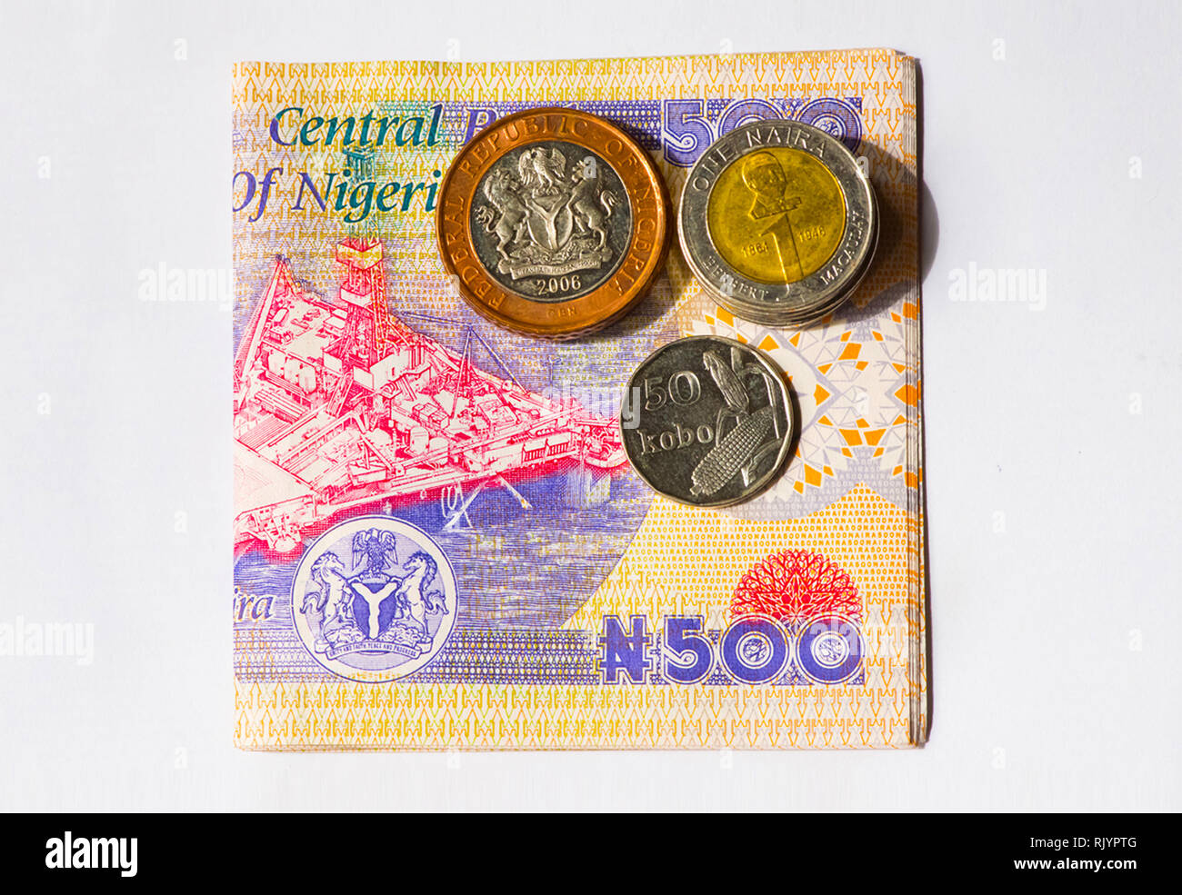 Nigerian Money - A folded wad of 500 Naira notes with some coins of ...