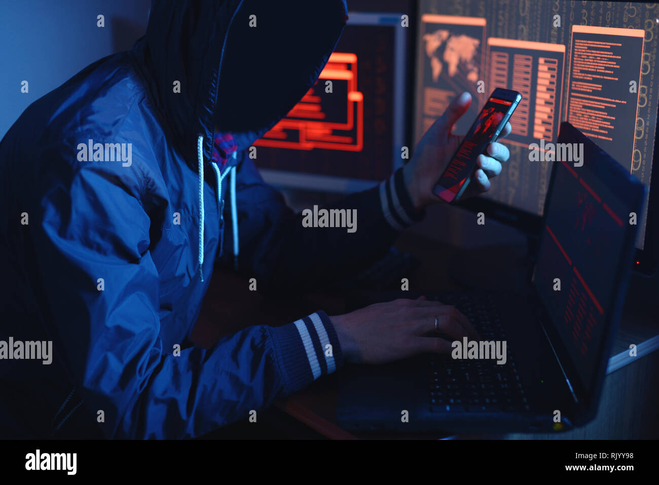 An anonymous hacker with no face typing the code tries to hack the ...
