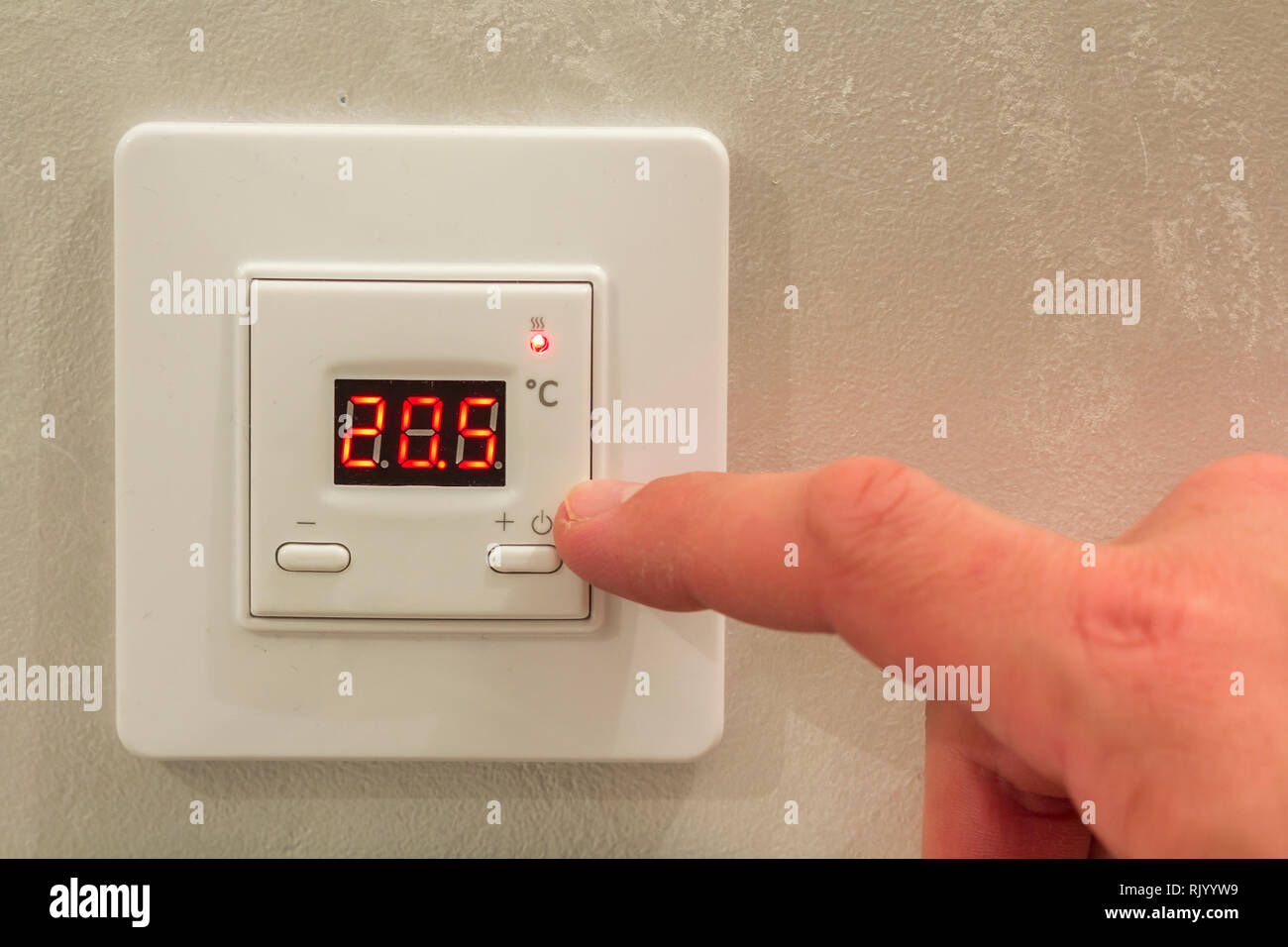 White electronic programmable digital thermostat on light wall copy ...