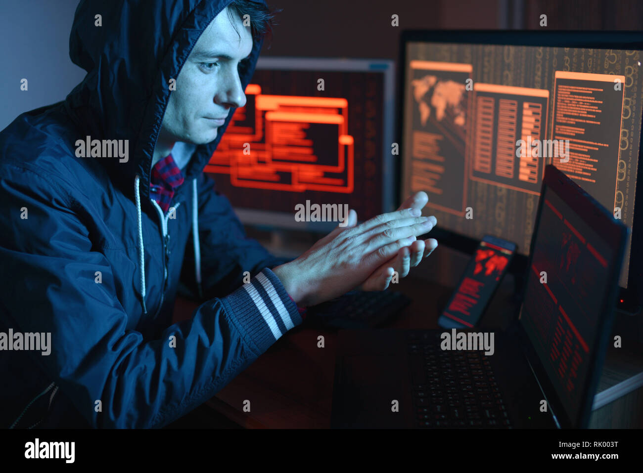 Male hacker celebrates success with a hand gesture. A successful ...