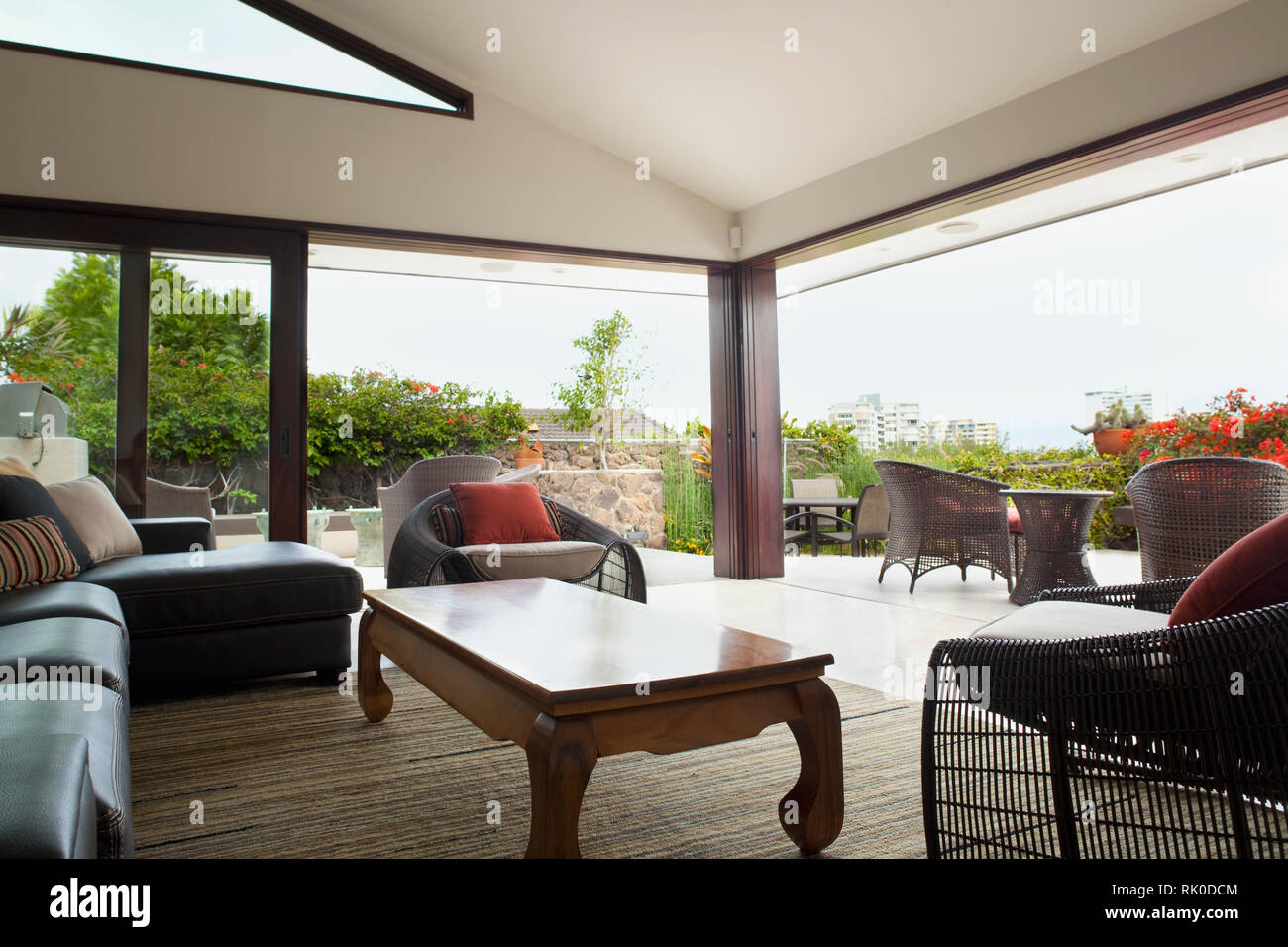 Modern living room overlooking patio Stock Photo - Alamy