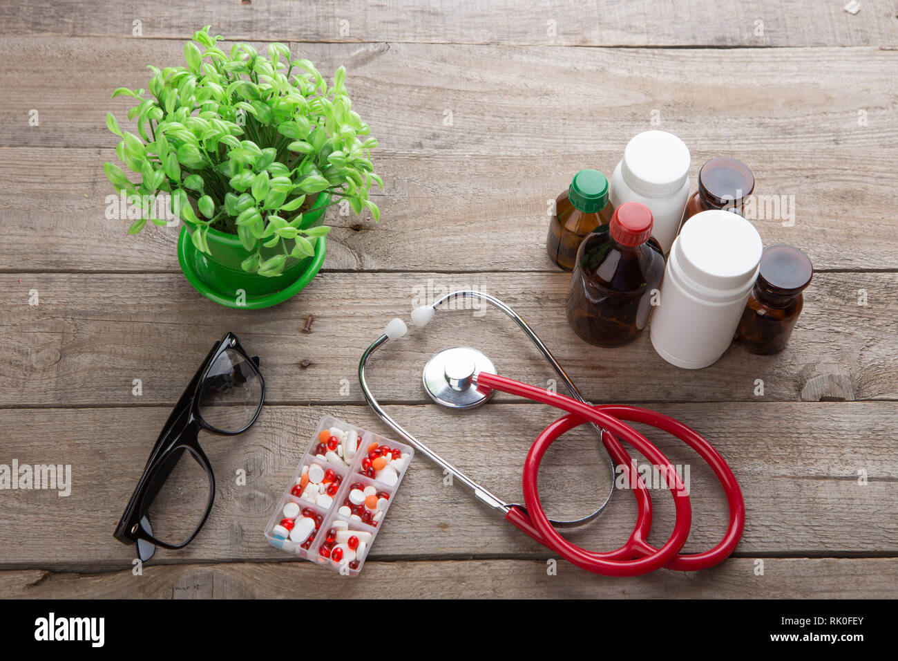Workplace of a doctor. Stethoscope and drugs on the wooden desk Stock ...