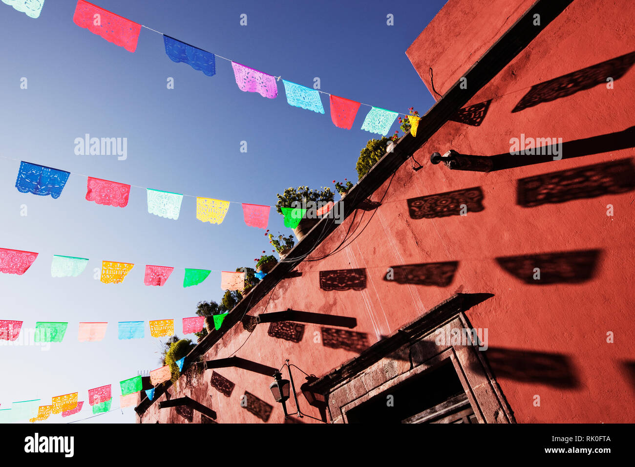 Multicolor banners against blue sky, San Miguel de Allende, Guanajuato ...