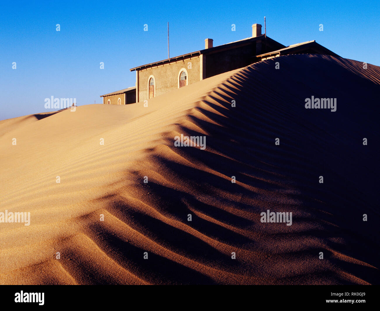 House Buried in Sand Stock Photo - Alamy