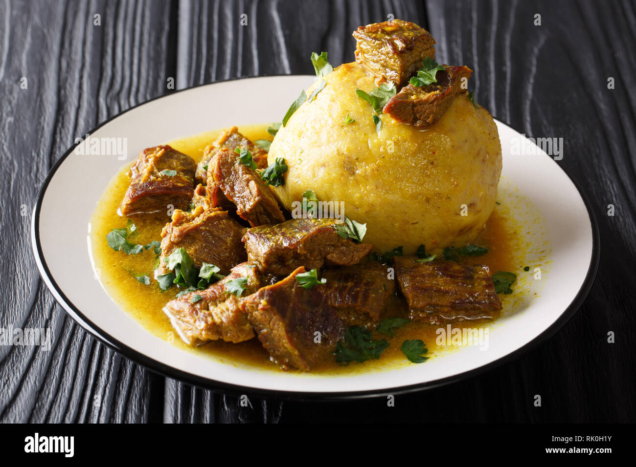 Spicy mofongo with plantains, garlic and chicharron served with meat ...